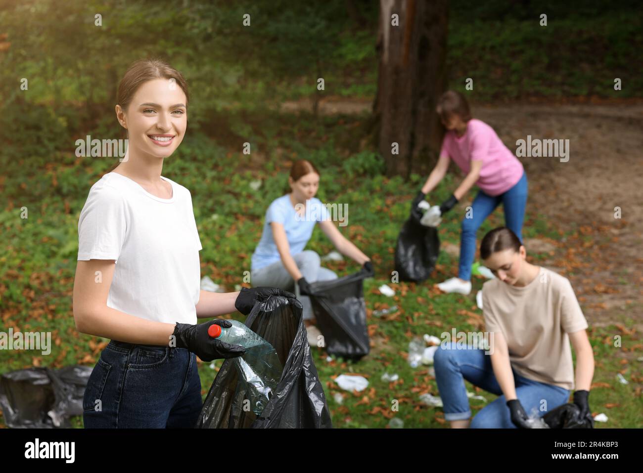 Group of people with plastic bags collecting garbage in park Stock ...