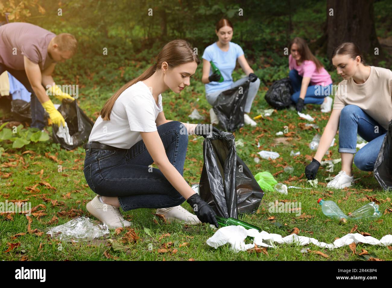 Group of people with plastic bags collecting garbage in park Stock ...