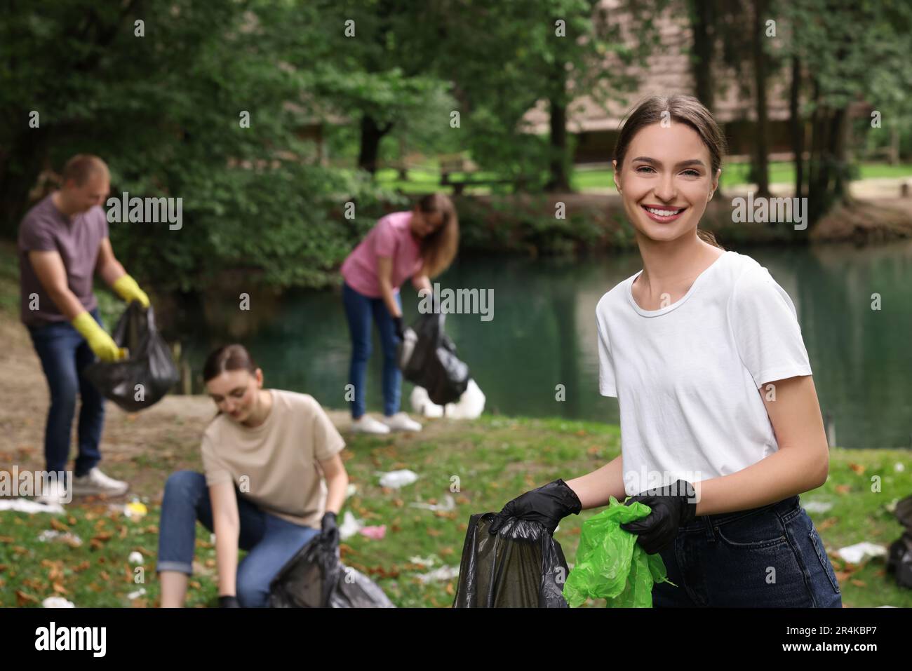 Group of people with plastic bags collecting garbage in park Stock ...