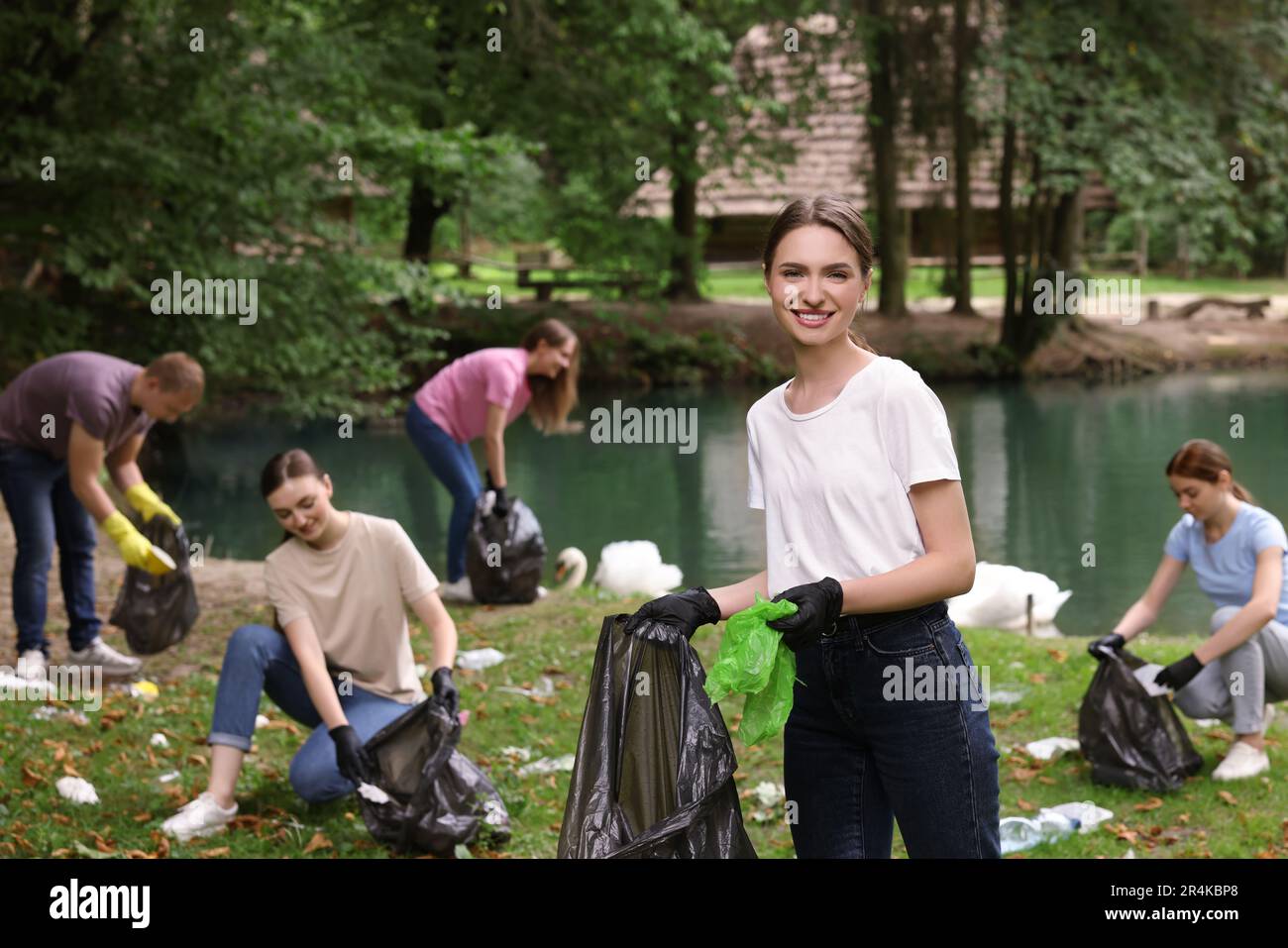 Group of people with plastic bags collecting garbage in park Stock ...