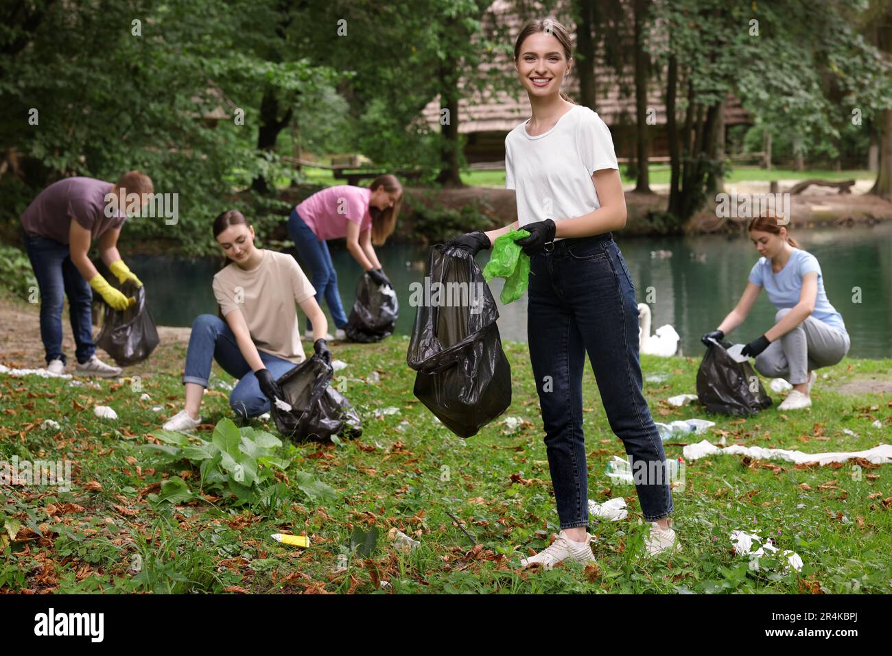 Group of people with plastic bags collecting garbage in park Stock ...