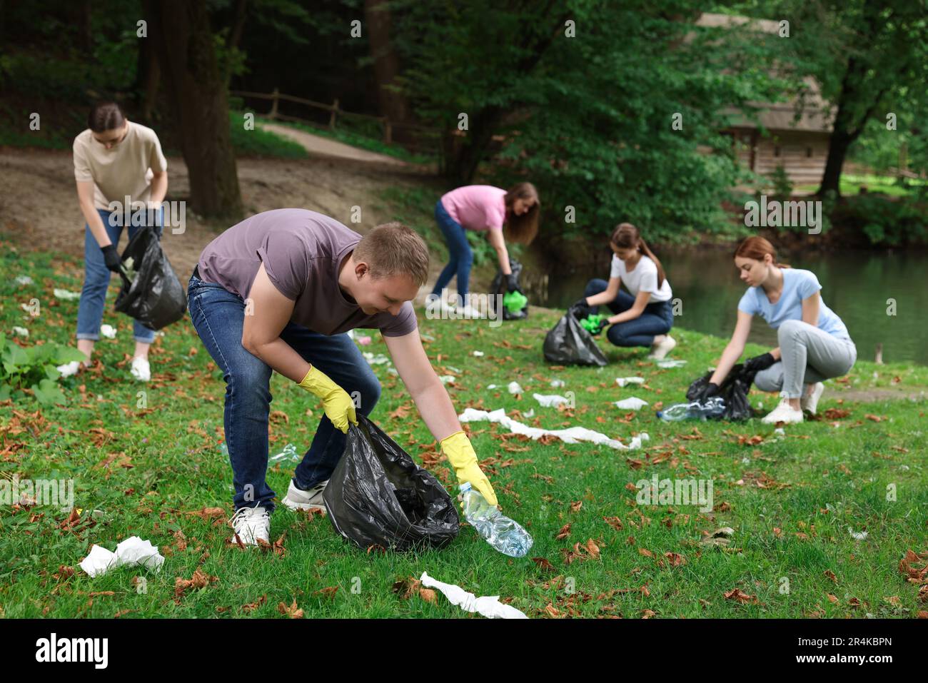 Group of people with plastic bags collecting garbage in park Stock ...