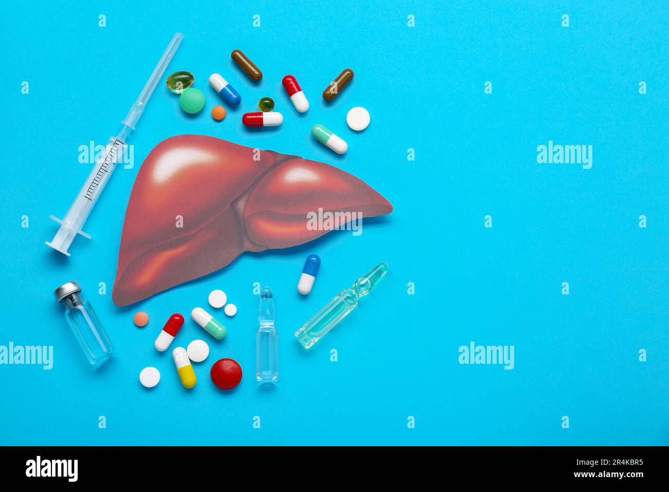 Paper liver, syringe, vials and pills on light blue background, flat ...
