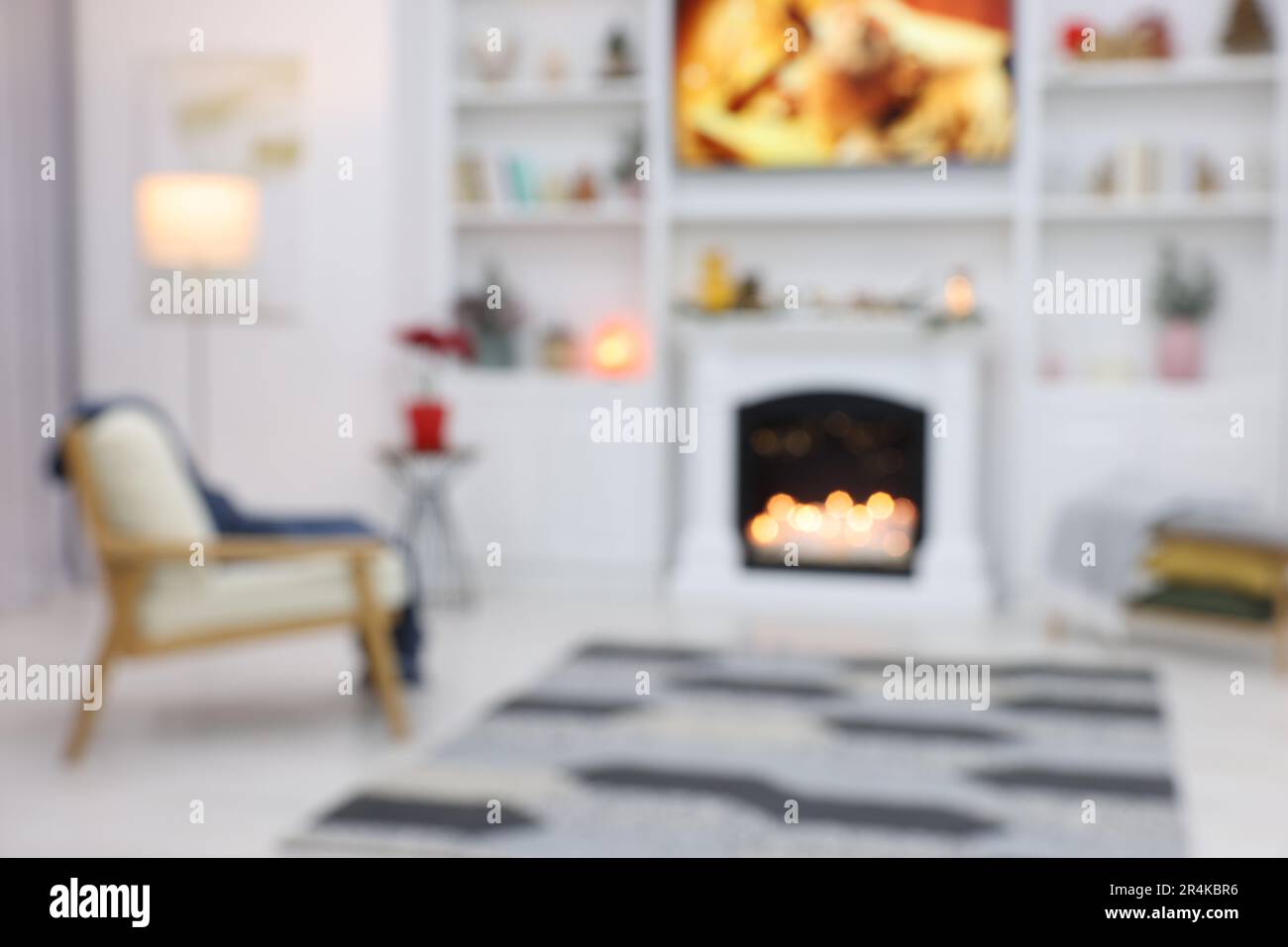 Blurred view of beautiful living room with Christmas decor, fireplace ...