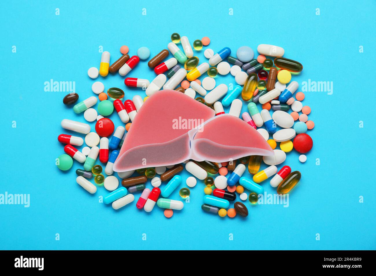 Paper liver and pills on light blue background, flat lay. Hepatitis ...