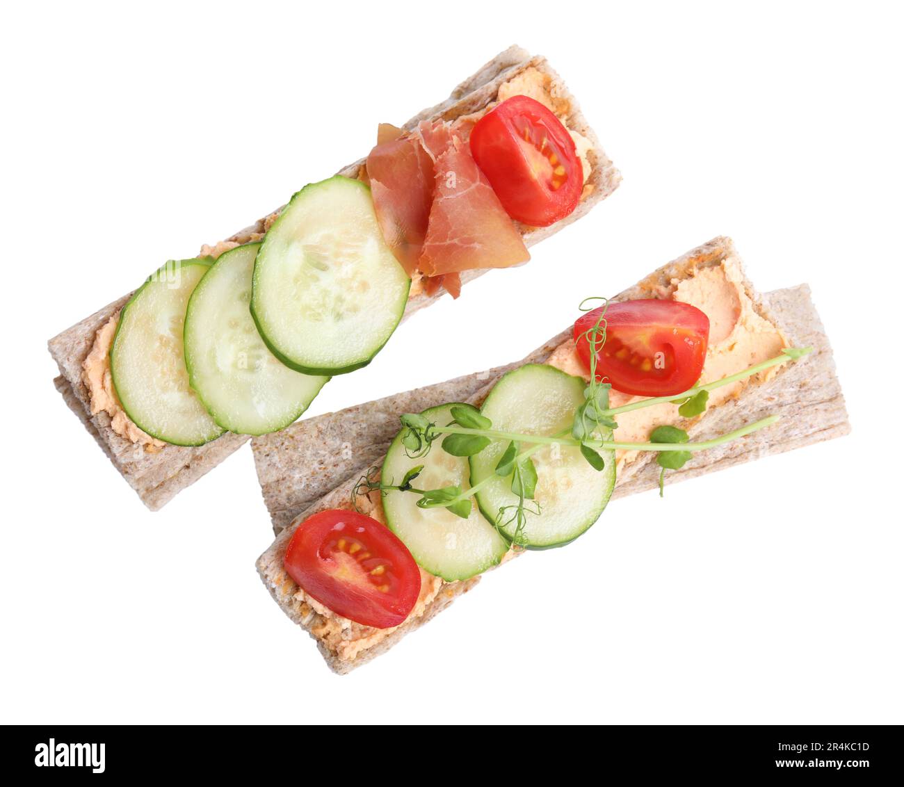 Tasty crispbreads with cream cheese and fresh vegetables isolated on ...