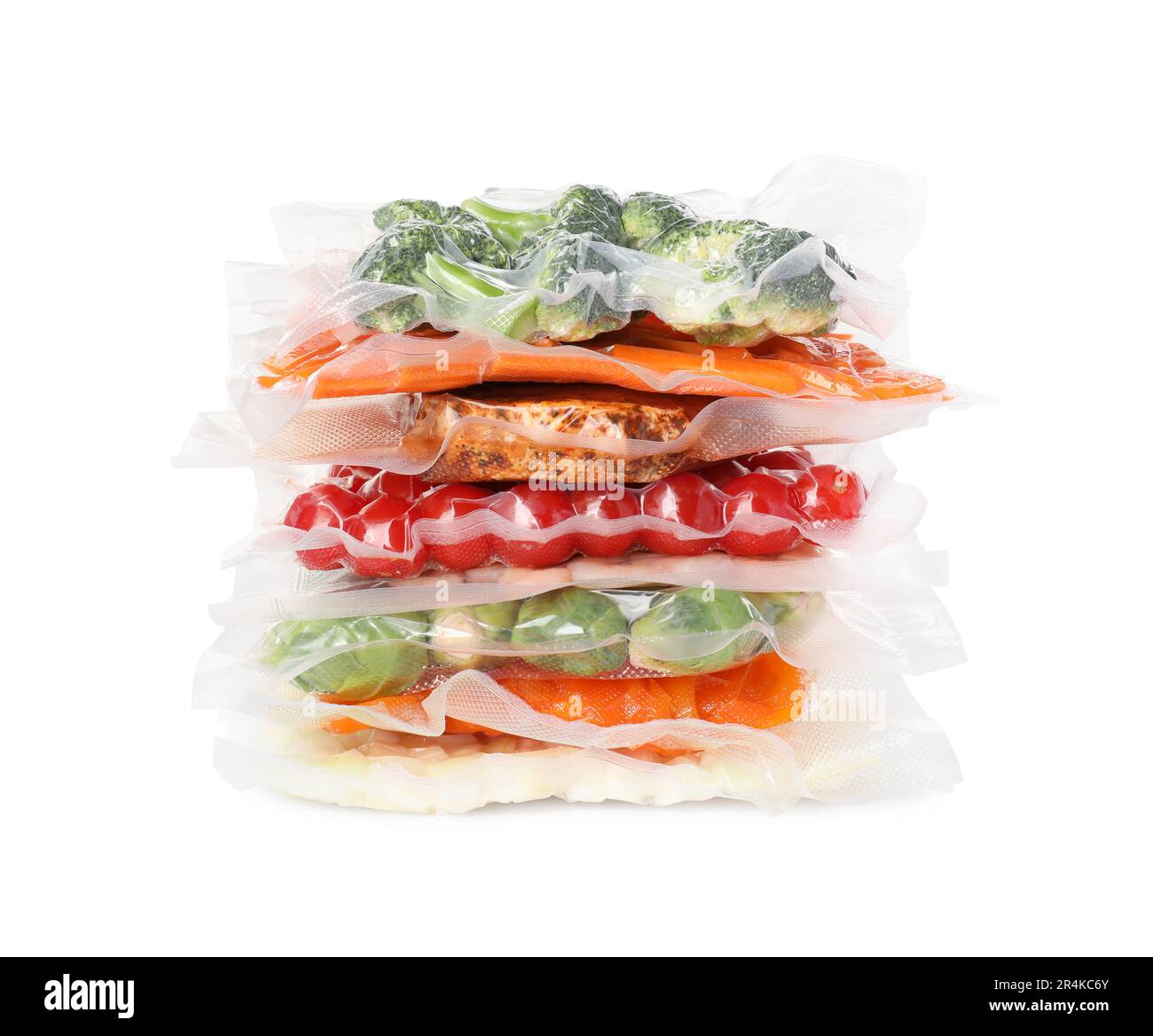 Stack of vacuum packs with different food products on white background ...