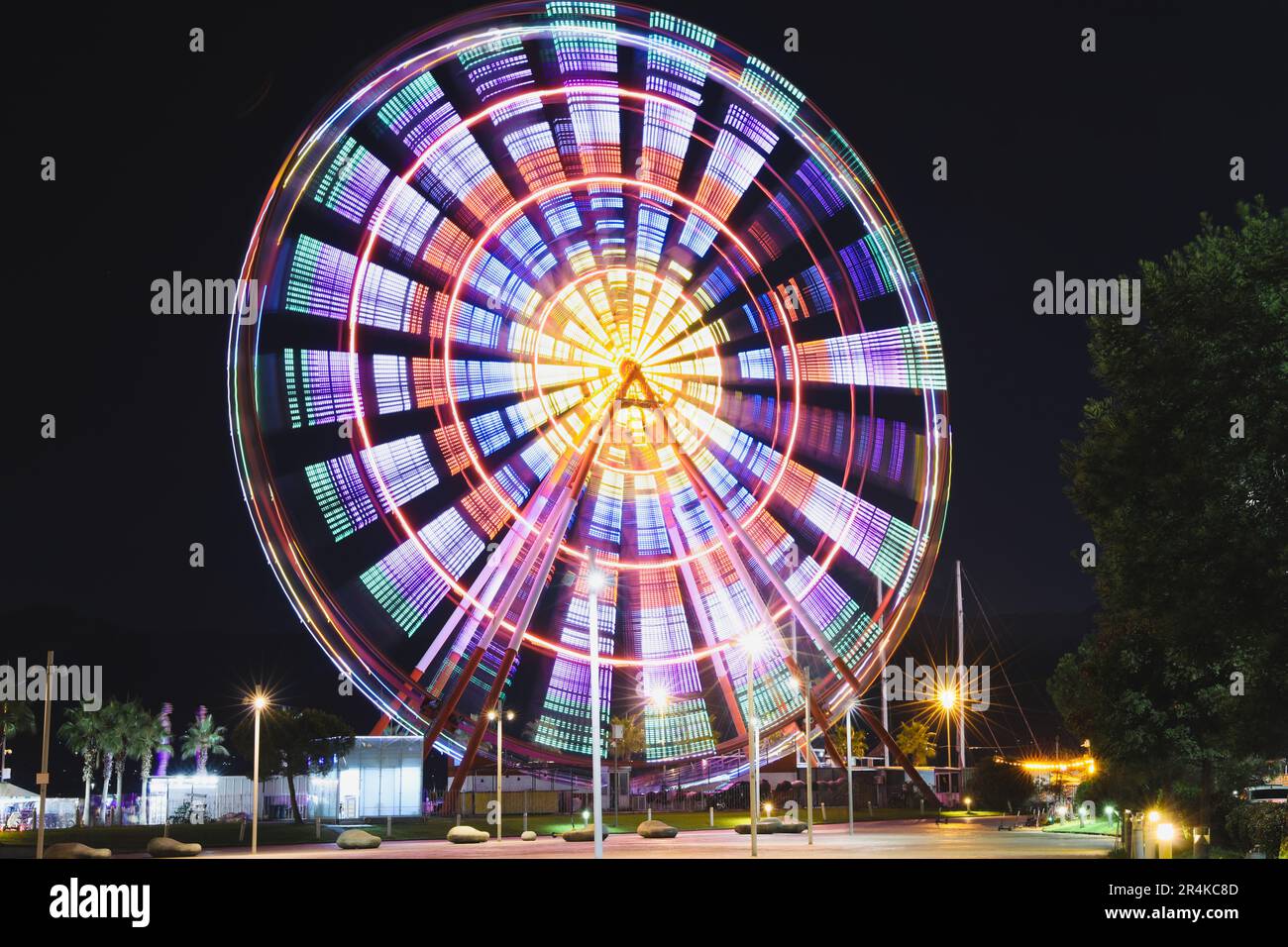 Beautiful glowing Ferris wheel against dark sky Stock Photo - Alamy