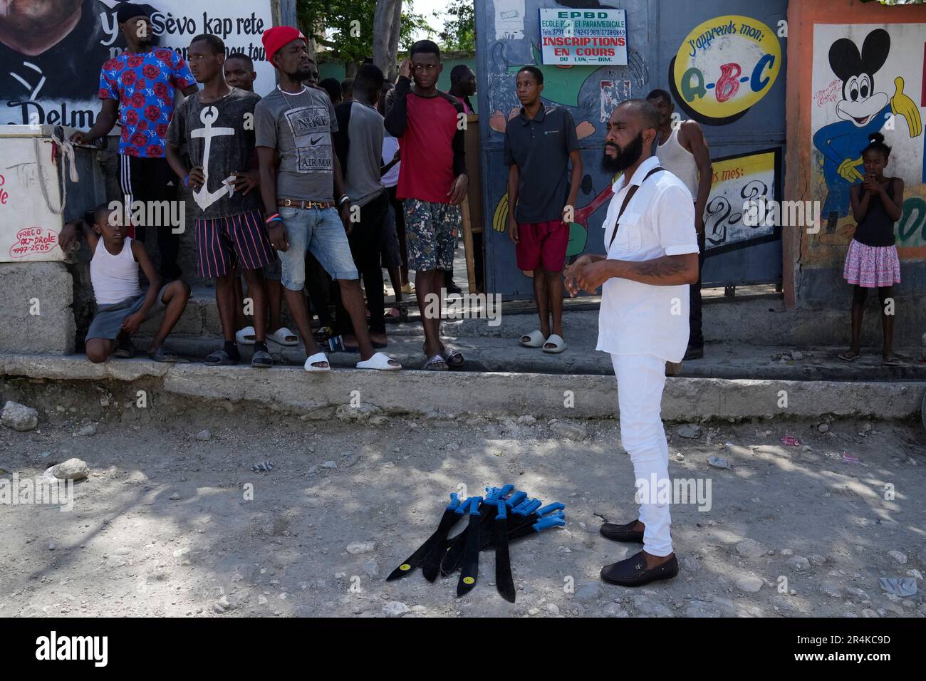 Nertil Marcelin, center, leader of a community group stand with ...