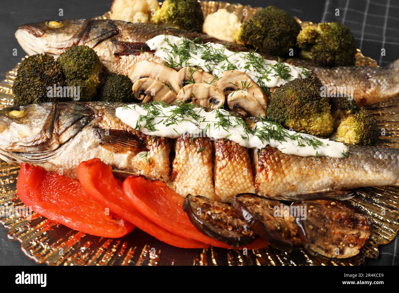 Delicious baked sea bass fish with sauce on plate, closeup Stock Photo ...