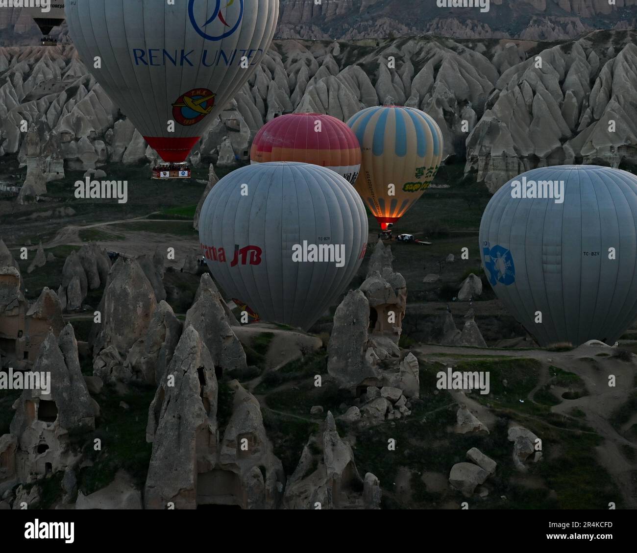 Hot air balloons lifting off at the beginning of a sunrise flight, near ...