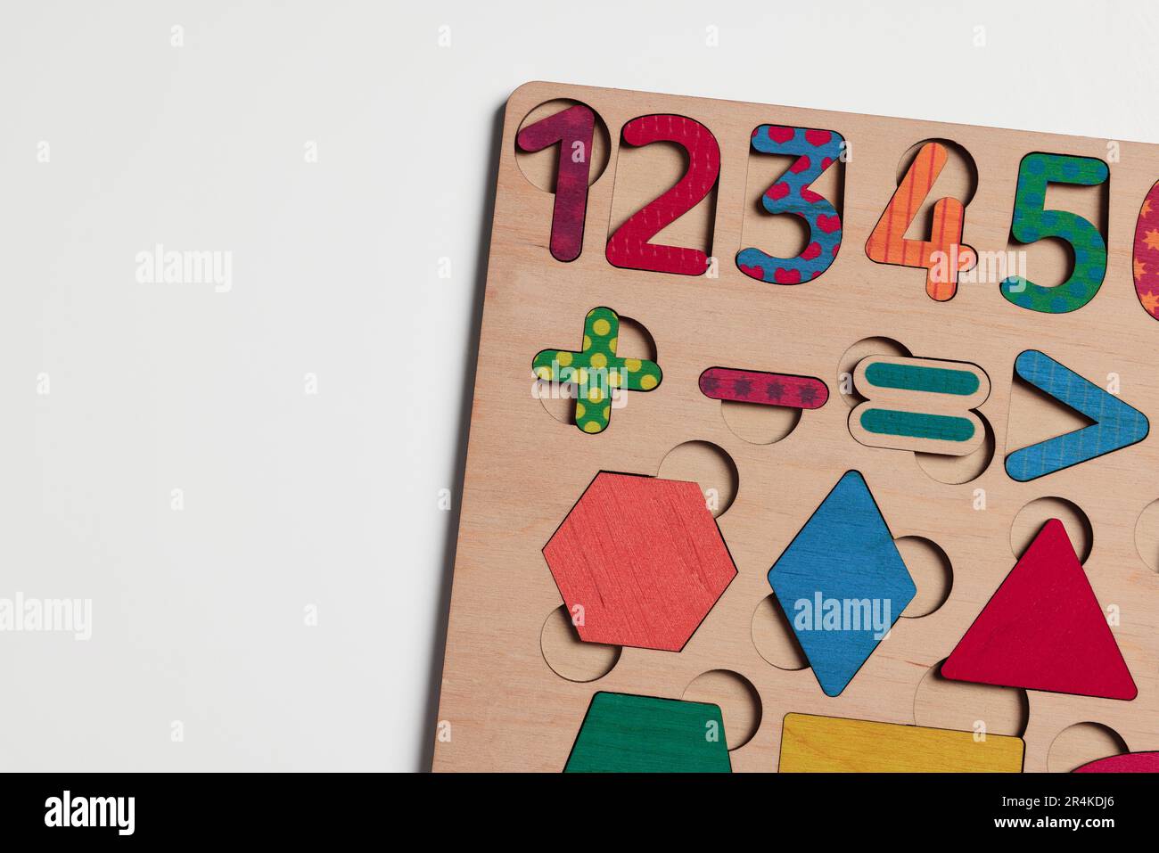 Wooden math game kit for children on white table, top view. Space for ...