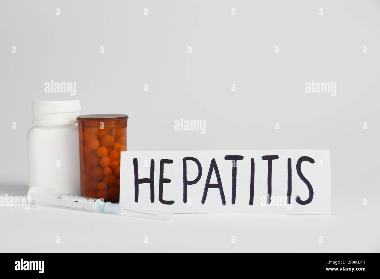 Word Hepatitis and bottles of pills on white background Stock Photo - Alamy