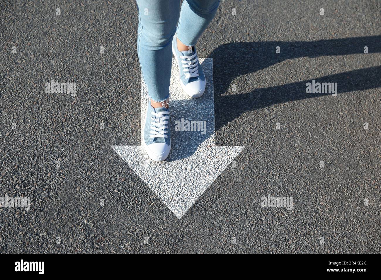 Planning future. Woman walking on drawn mark on road, closeup. White ...