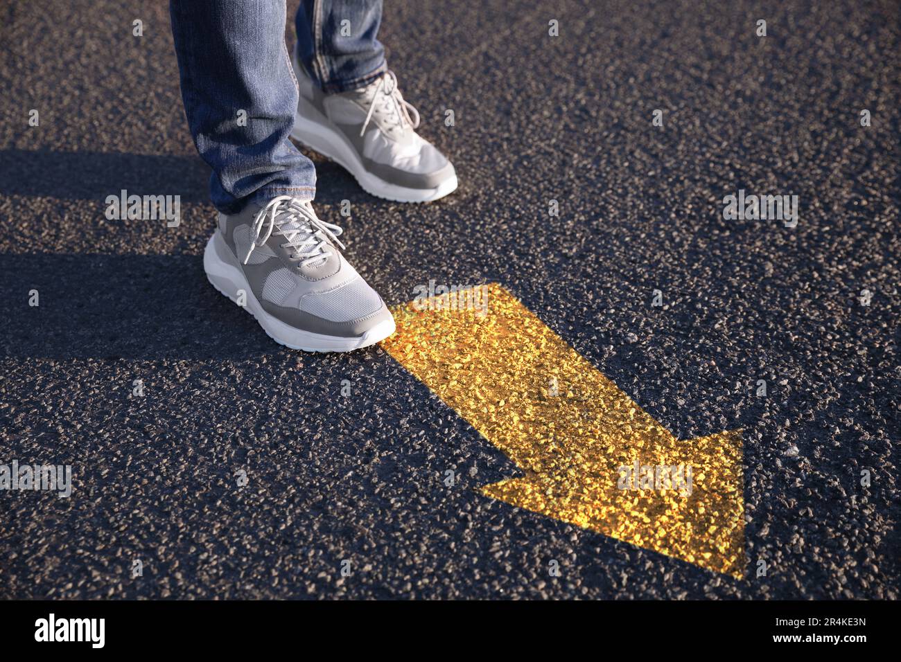 Planning future. Man walking to drawn mark on road, closeup. Yellow ...