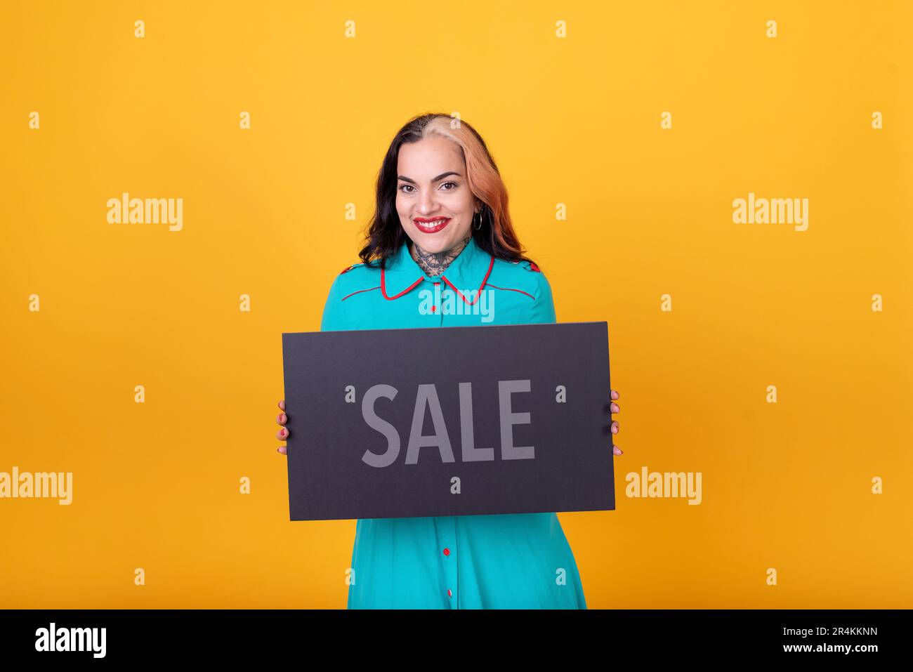 Beautiful woman holding a Sale sign Stock Photo - Alamy