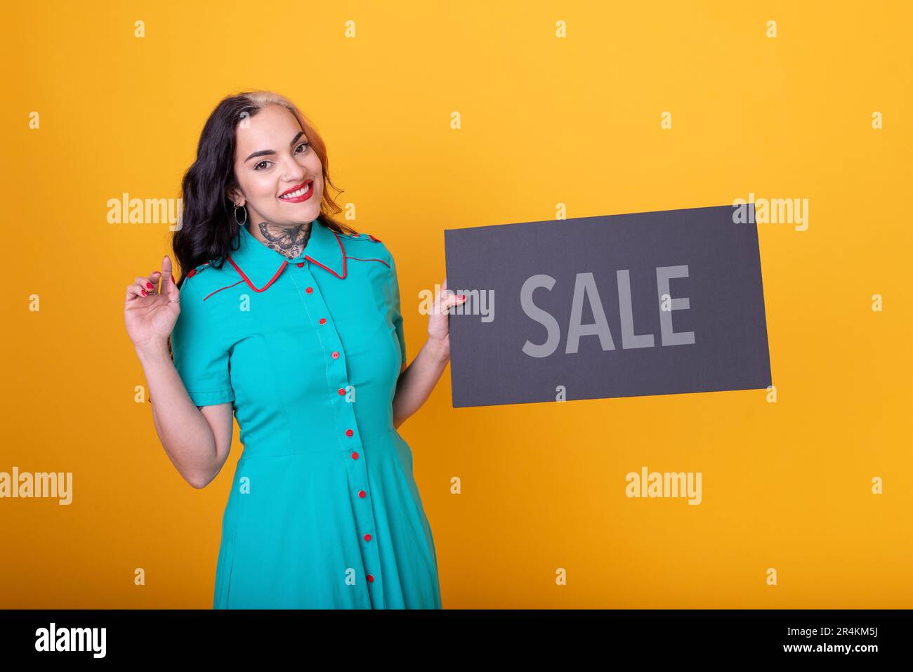 Beautiful woman holding a Sale sign Stock Photo - Alamy