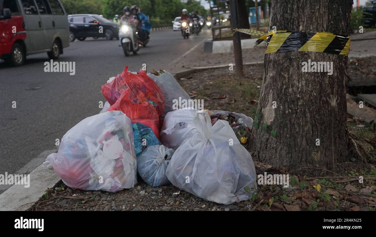 Garbage Plastic Bag At Roadside Stock Photo - Alamy