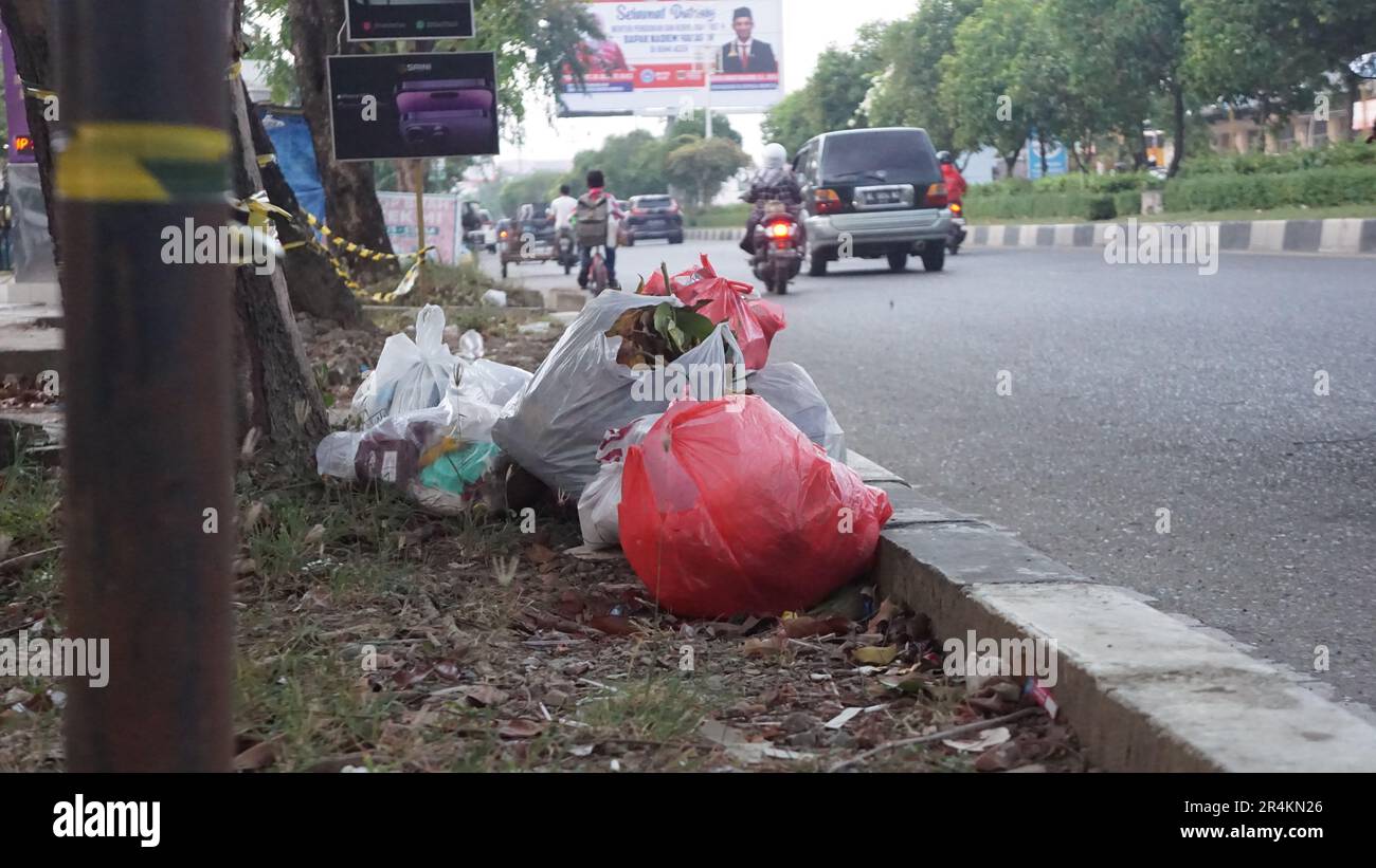 Garbage Plastic Bag At Roadside Stock Photo - Alamy