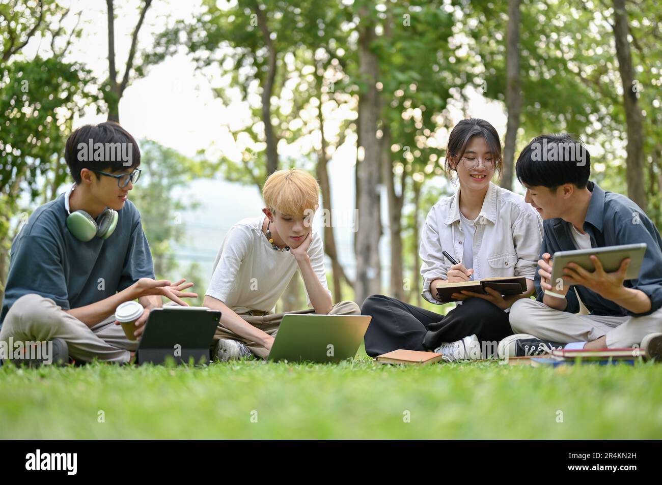 A group of diverse young Asian college students are doing a school ...