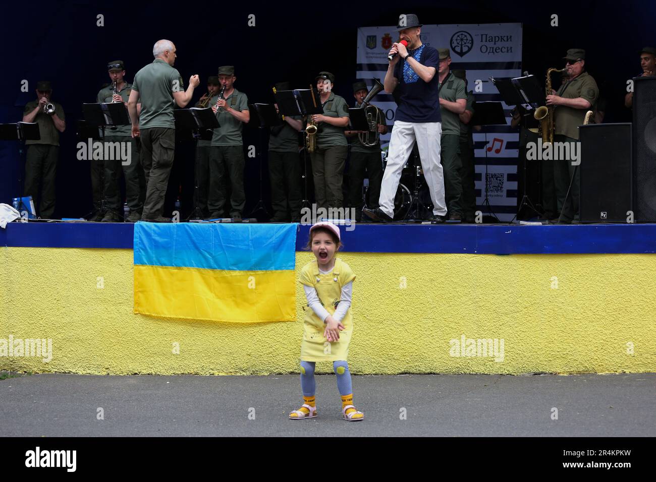 A girl seen against the background of the performance of the artist in ...