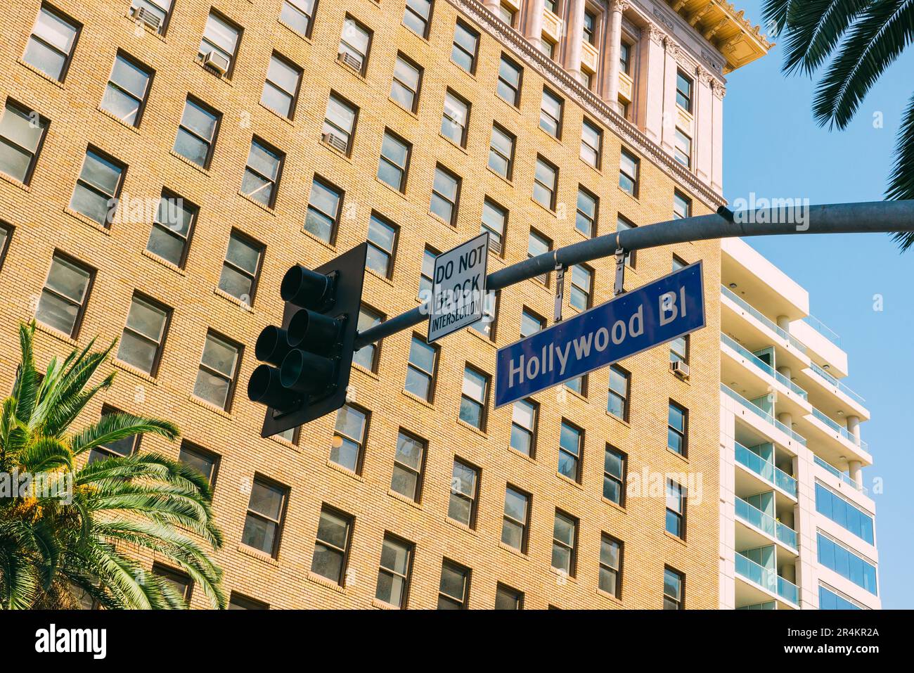 Hollywood Boulevard road sign and traffic light with modern building in ...