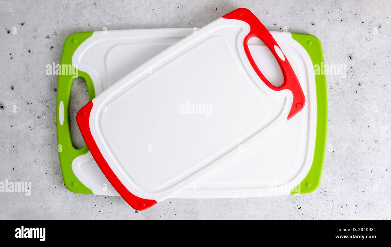 Set of plastic cutting boards in different colors and sizes close-up ...