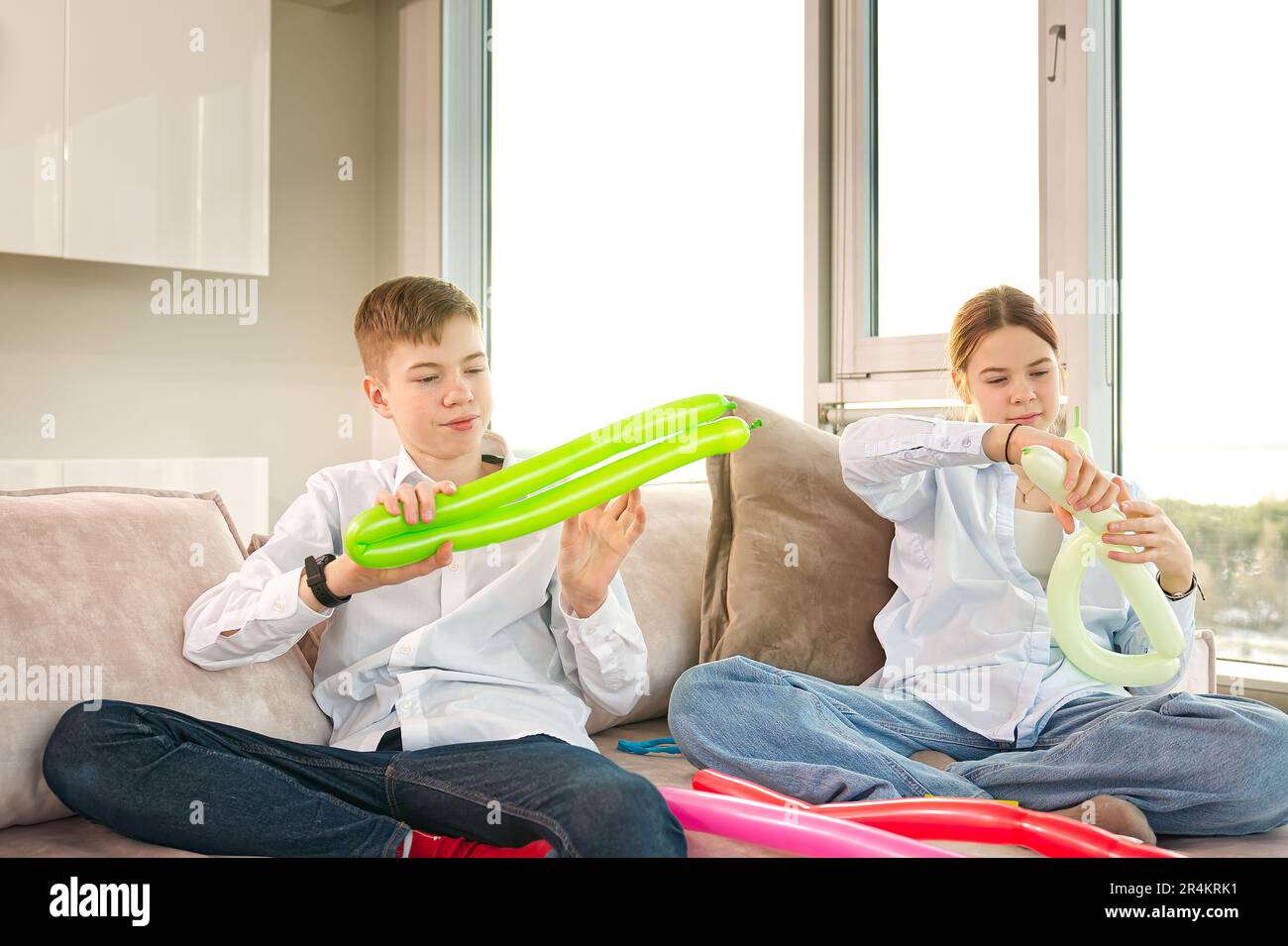 Children inflate modelling balloons. kids having fun with balloons ...