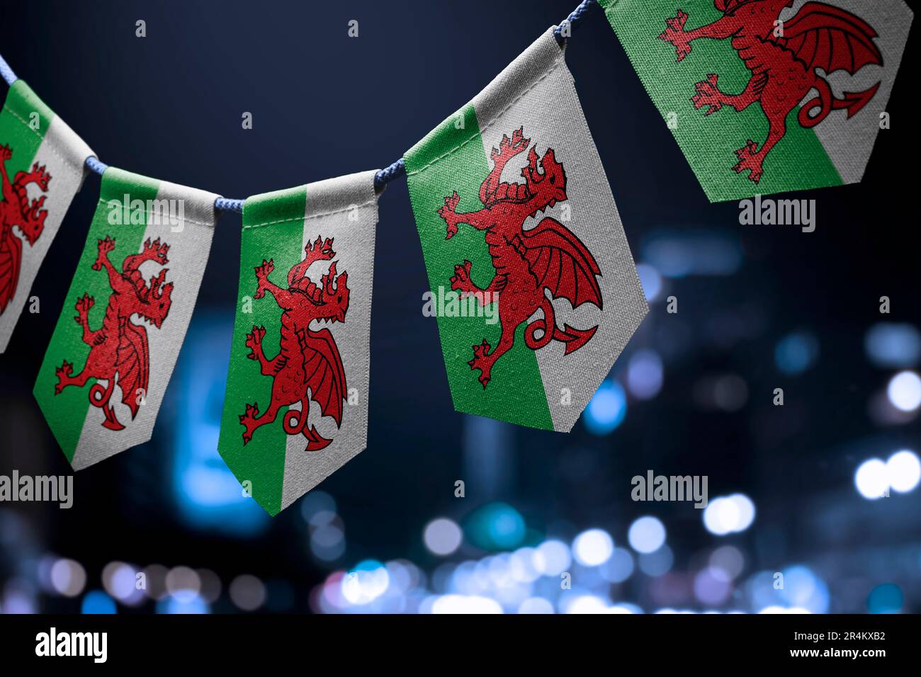A garland of Wales national flags on an abstract blurred background ...