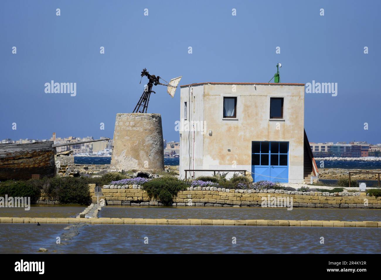 Landscape with scenic view of a traditional mill in the salt pan Salina Calcara, Nubia Natural ...