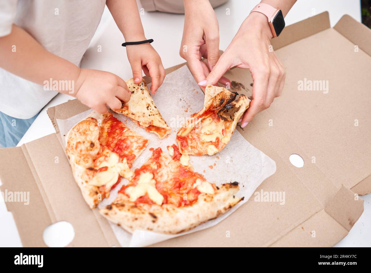 Mother and daughter had a pizza picnic in the park. Pizza delivery ...
