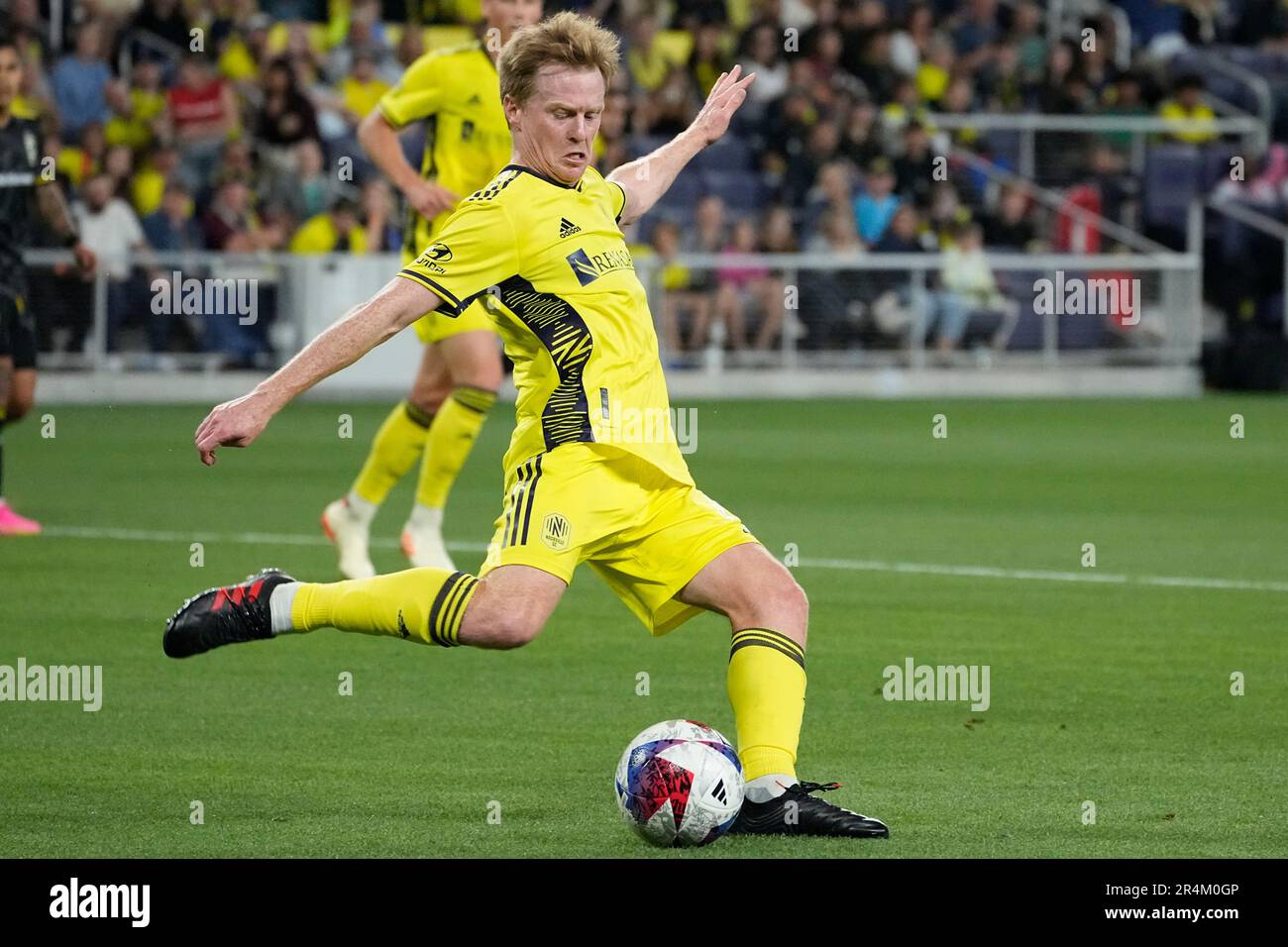 Nashville SC midfielder Dax McCarty kicks the ball across the field ...