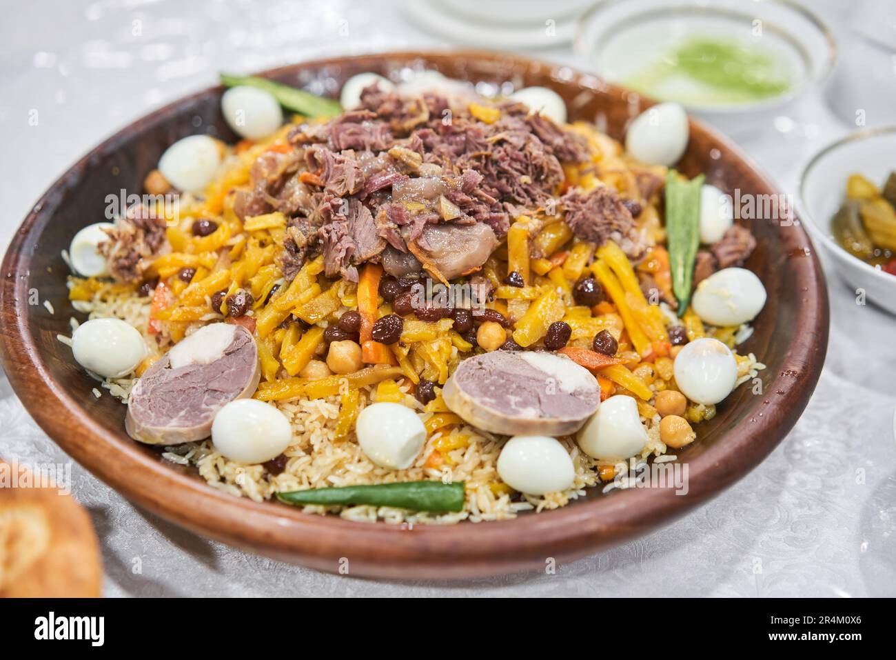 A traditional Uzbek dish called pilaf with meat, carrots, onions, quail ...