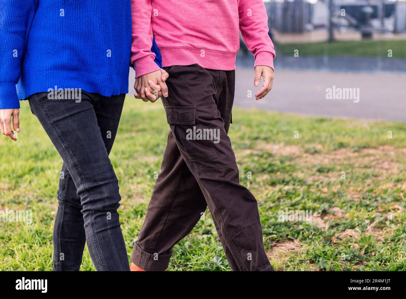 two people walking together holding hands Stock Photo - Alamy
