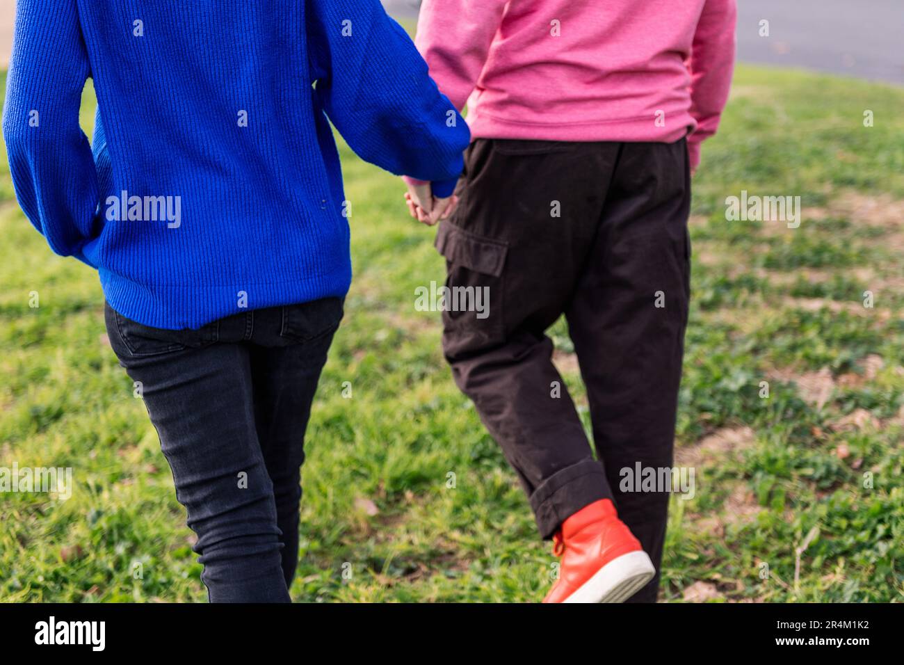 two people walking together holding hands Stock Photo - Alamy