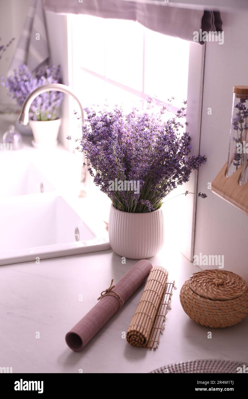 Beautiful lavender flowers on countertop near sink in kitchen Stock ...