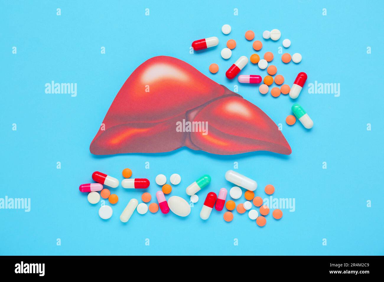 Paper liver and pills on light blue background, flat lay. Hepatitis ...