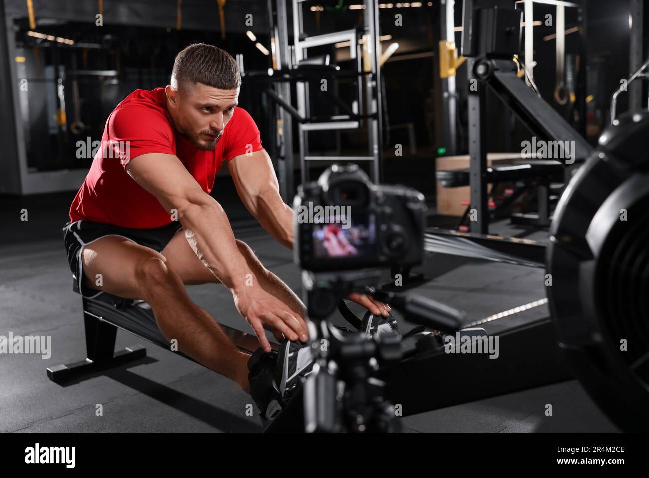 Man recording workout on camera at gym. Online fitness trainer Stock ...