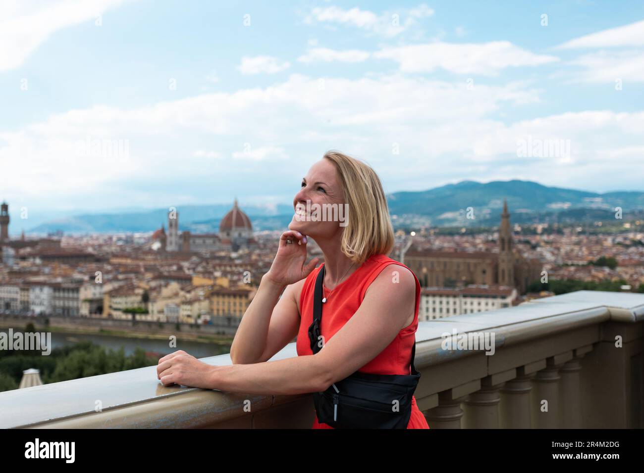 Woman stands against the backdrop of the panorama of Florence, Italy ...