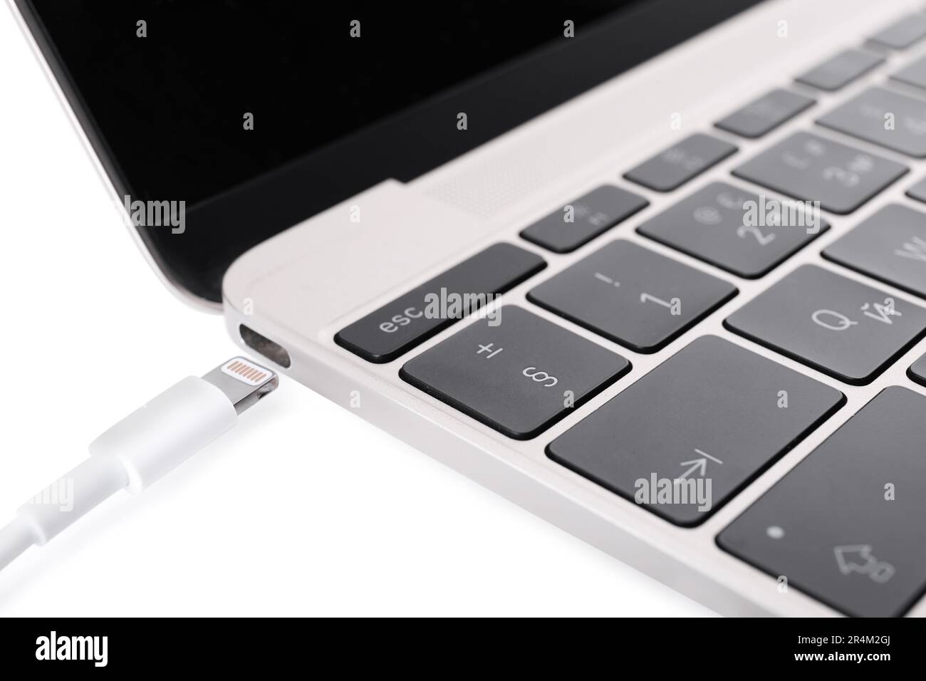 USB cable with lightning connector and laptop on white background Stock ...
