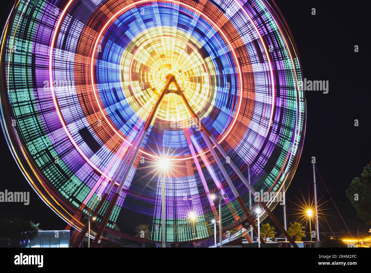 Beautiful glowing Ferris wheel against dark sky Stock Photo - Alamy