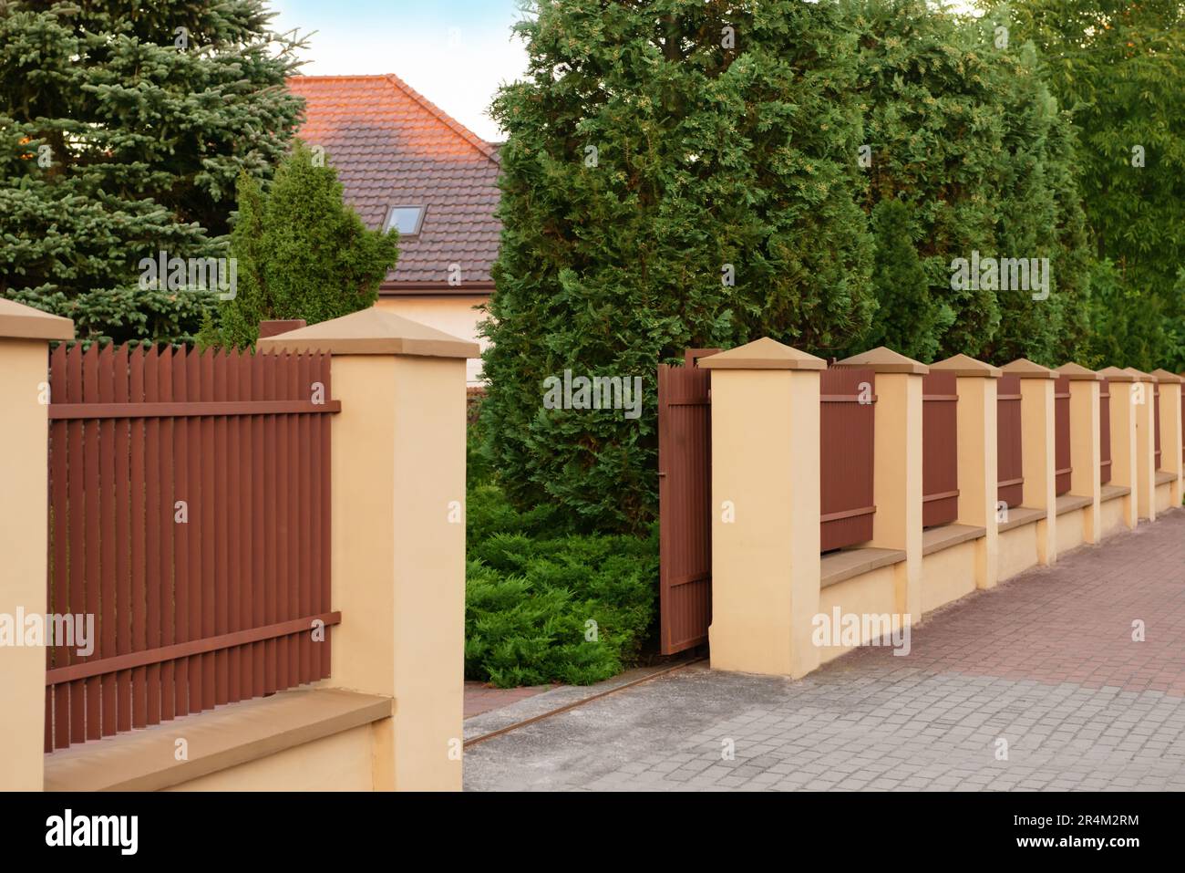 Open gates and beautiful fence with iron railing outdoors Stock Photo ...