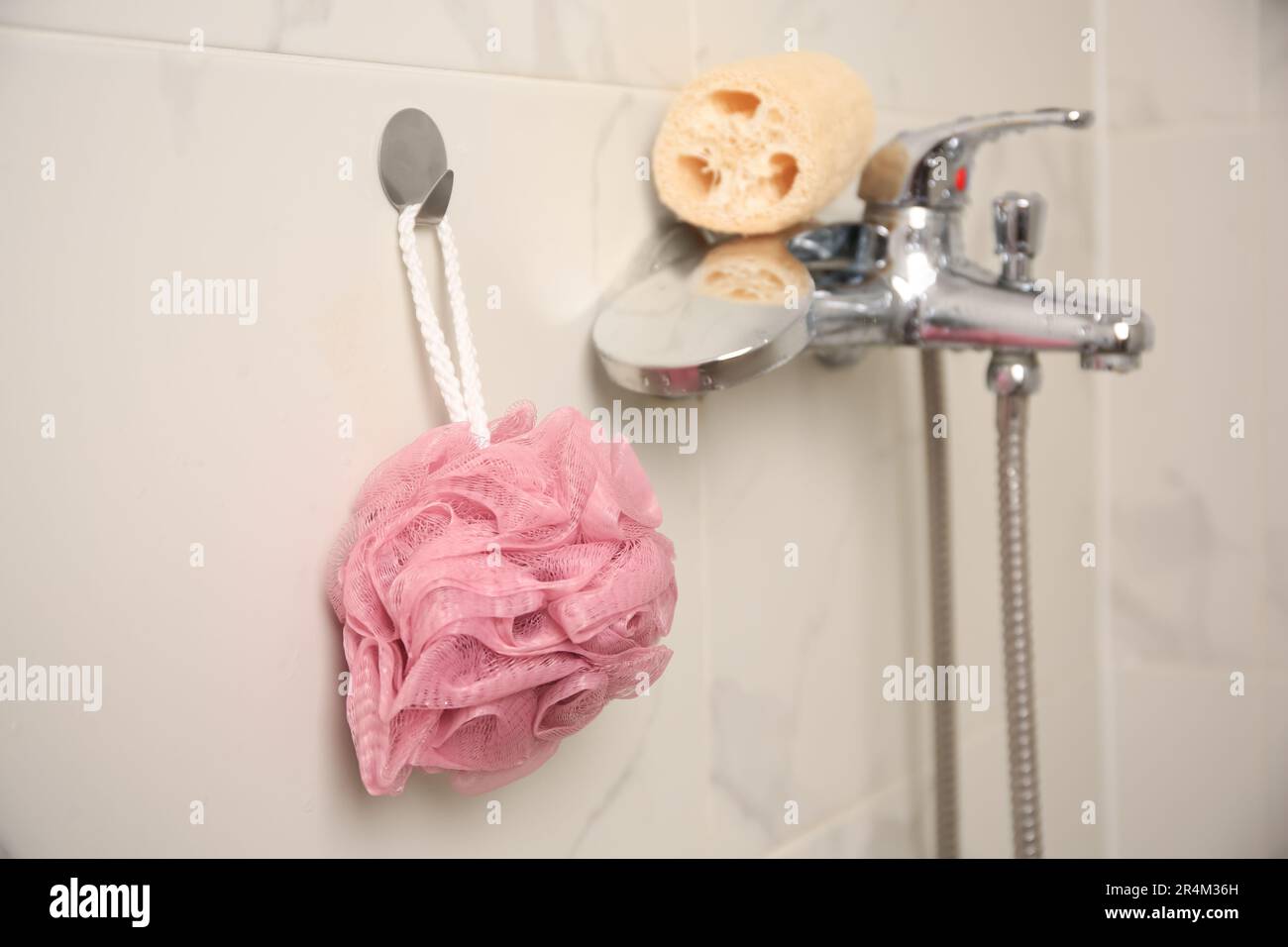 Pink shower puff and loofah sponge in bathroom Stock Photo - Alamy