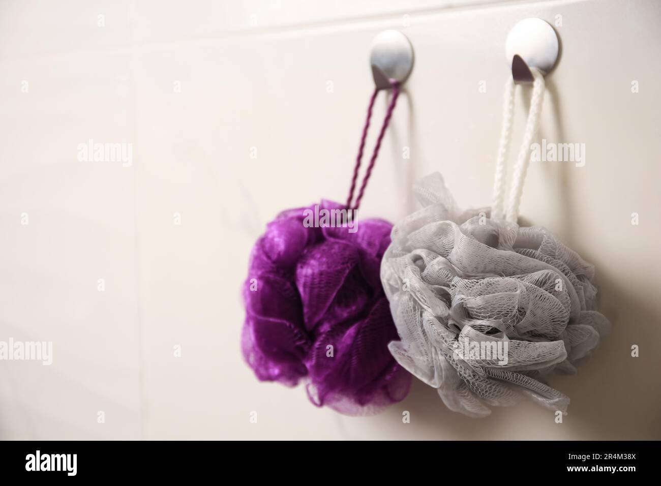 Shower puffs hanging in bathroom, space for text Stock Photo - Alamy