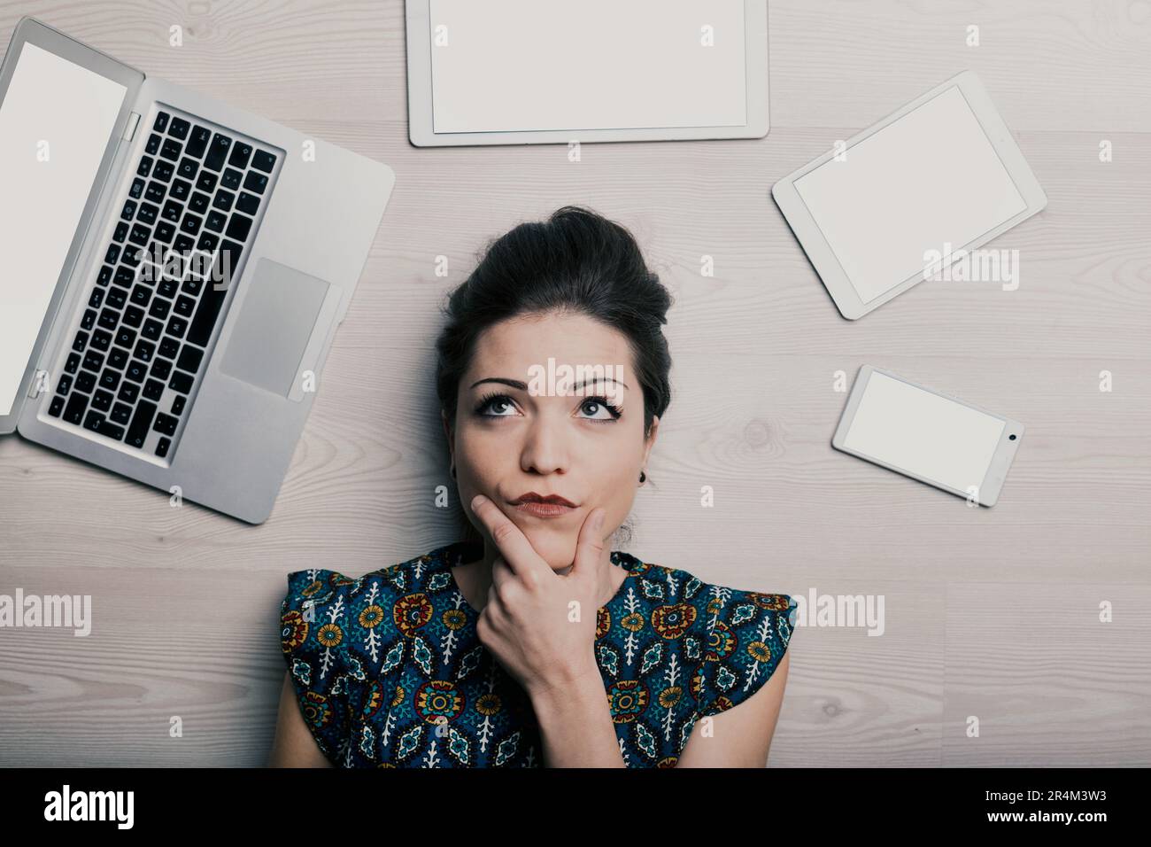 Concept of choice. A thoughtful, doubtful woman, viewed from above ...