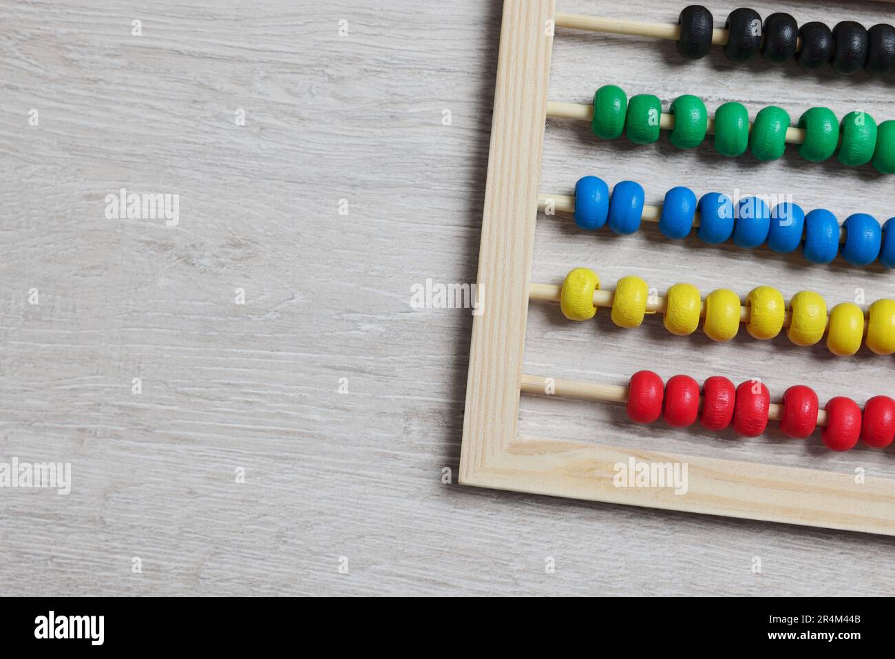 Funny math game. Colorful toy abacus on white wooden table, top view ...
