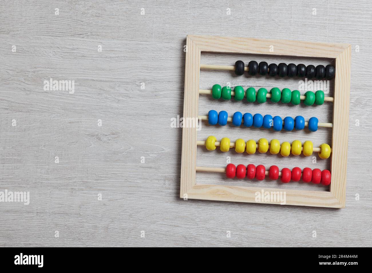 Funny math game. Colorful toy abacus on white wooden table, top view ...