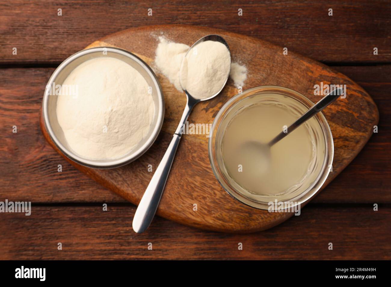 Glass of agar-agar jelly and powder on wooden table, top view Stock ...