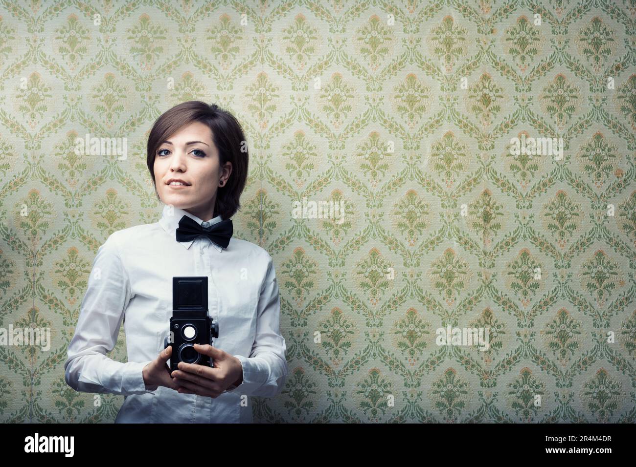 Short-haired woman, professional photographer, proudly grips a black ...