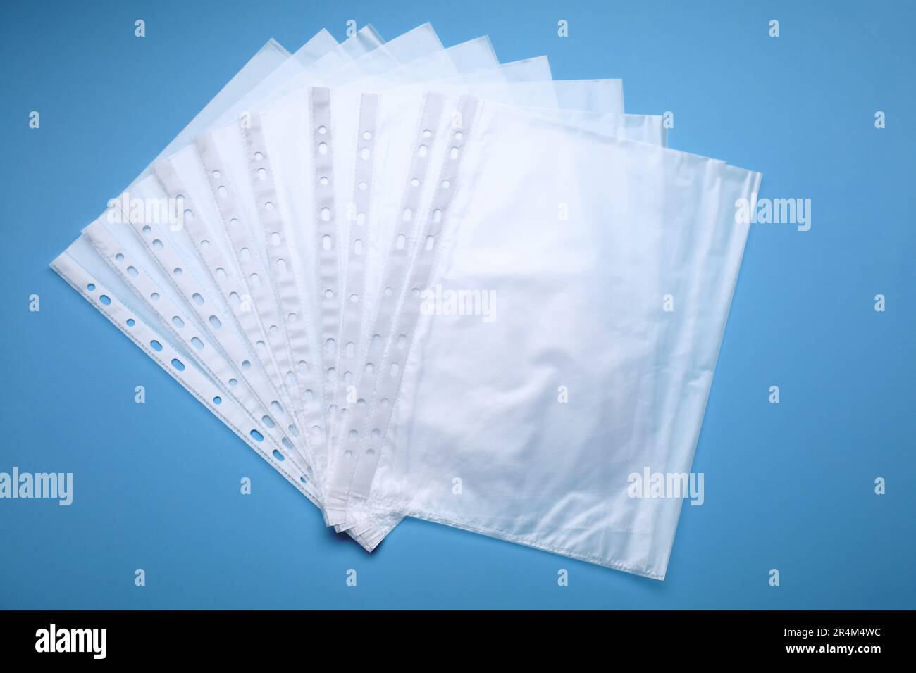 Punched pockets on light blue background, flat lay Stock Photo - Alamy